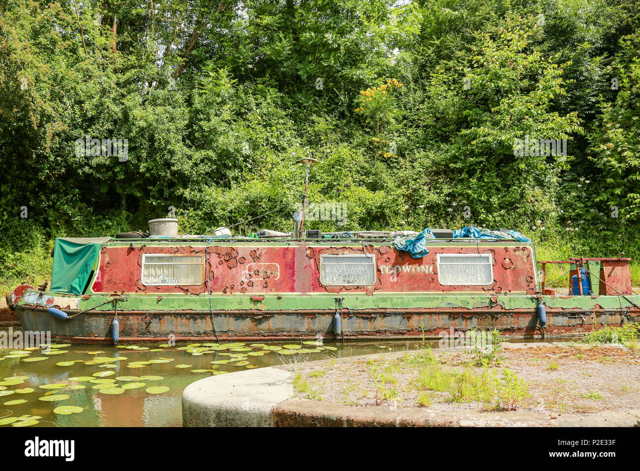A rusting narrow boat in bad state of repair Stock Photo - Alamy