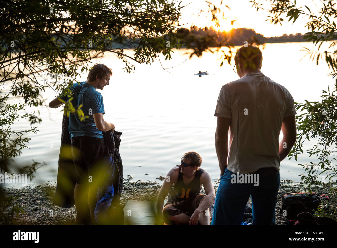 Three young men camping at a lake, Freilassing, Bavaria, Germany Stock ...