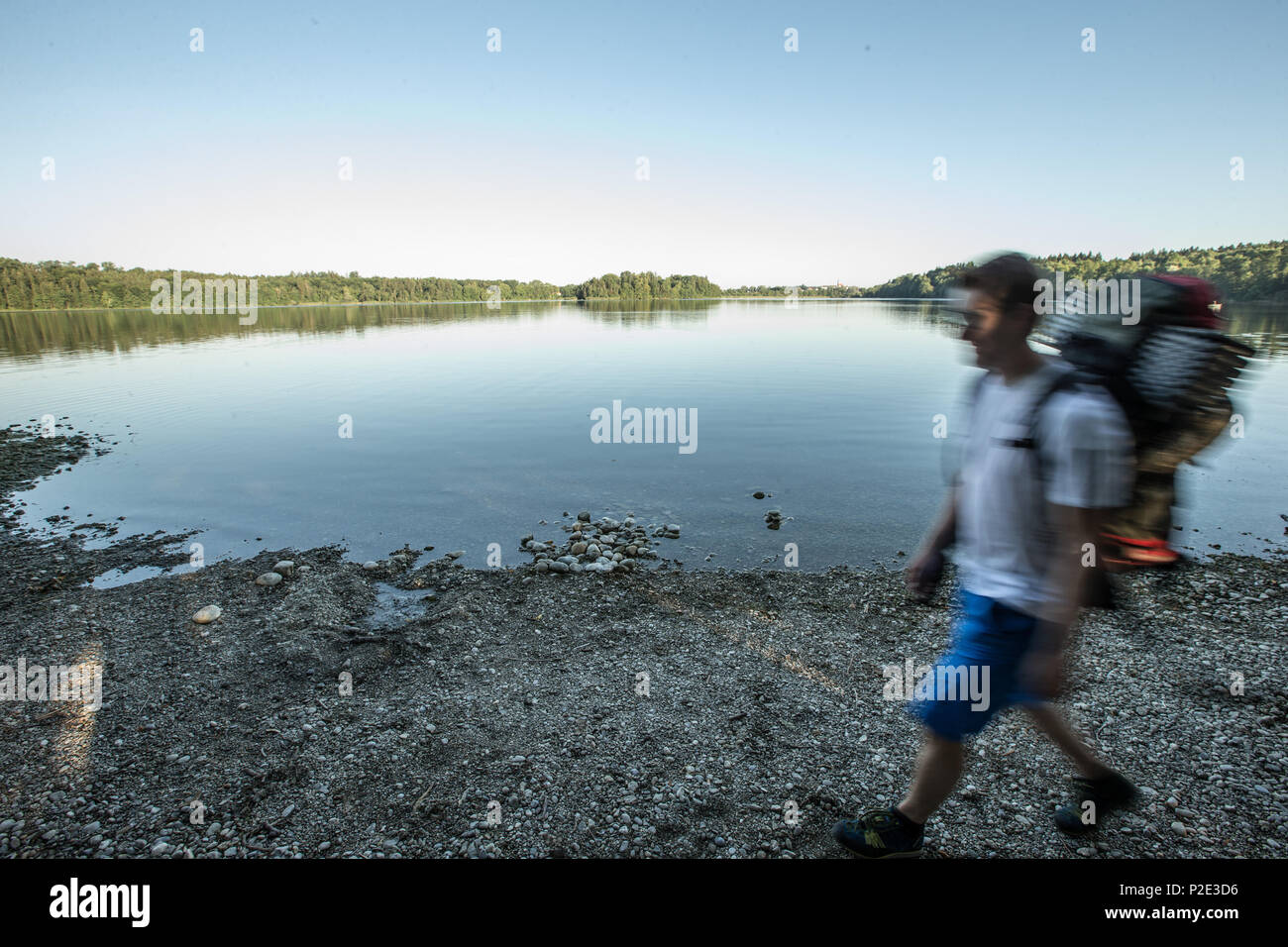 Young male camper walking at a lake, Freilassing, Bavaria, Germany ...