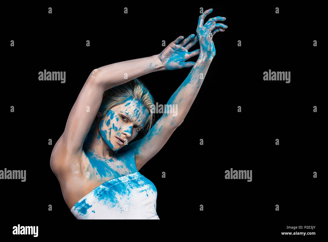 young woman posing in blue powder powder, isolated on black Stock Photo ...