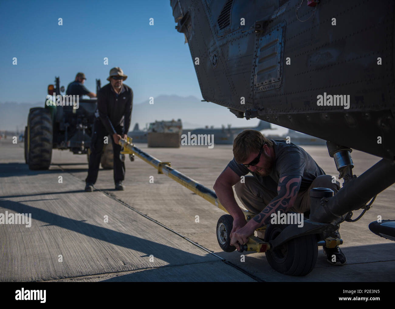 Michael Ballew, Department of Defense contractor, connects a tow bar to ...