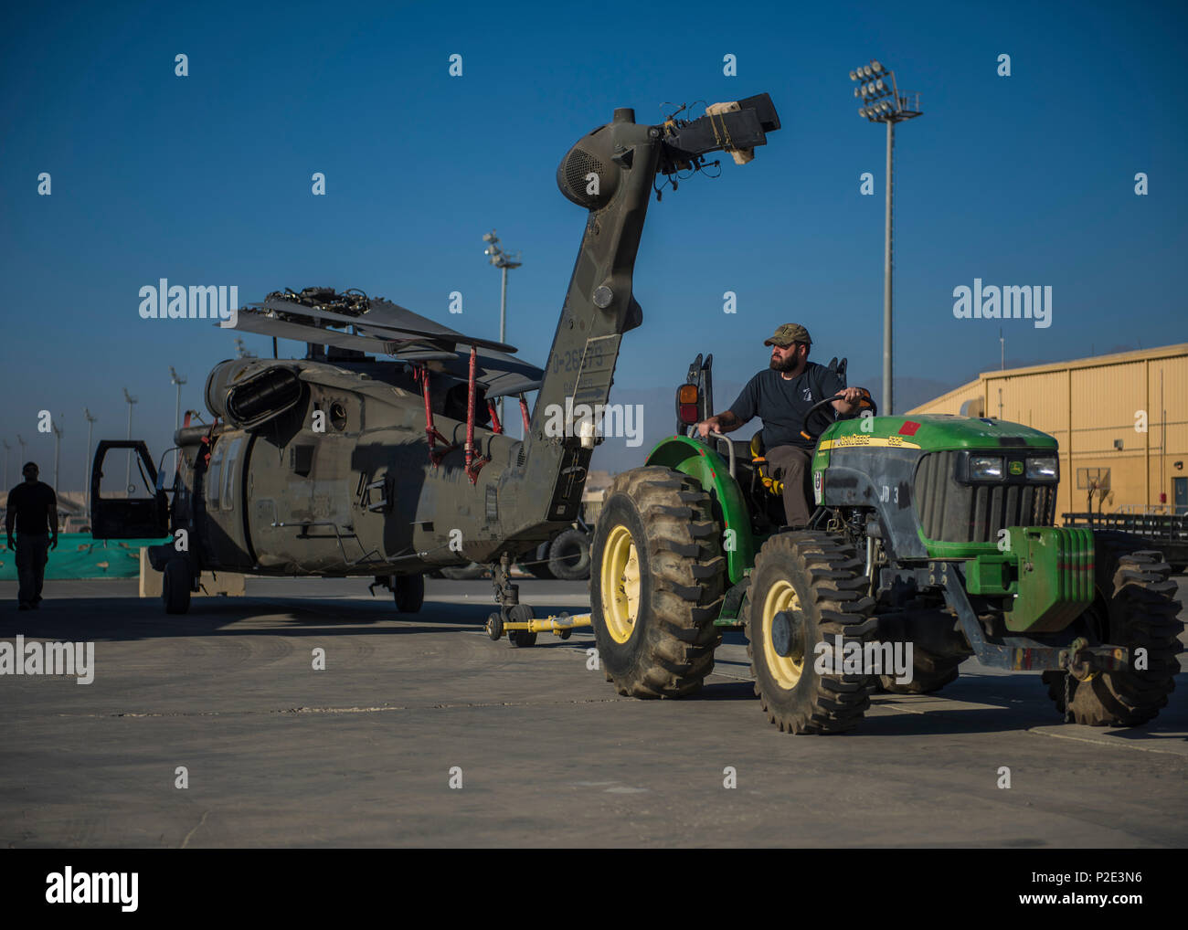 Anthony Fruge, Department of Defense contractor, uses a tractor to tow ...