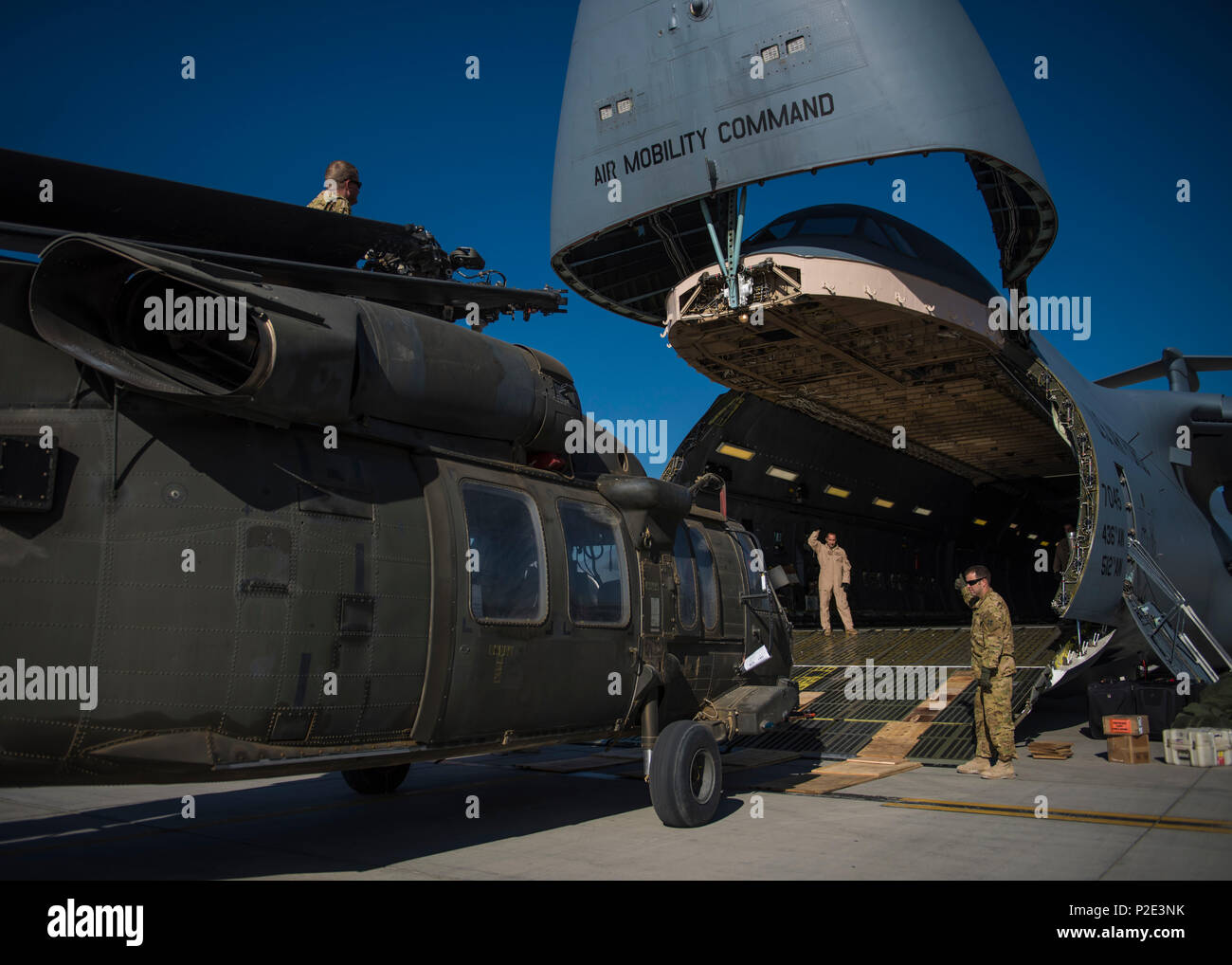 A Sikorsky UH-60 Blackhawk is hauled into a C-5 Galaxy for transport ...