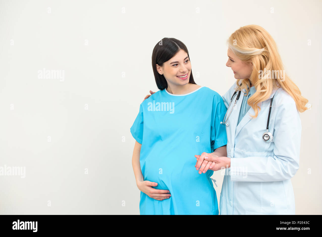 obstetrician gynecologist helping pregnant woman to walk and holding ...