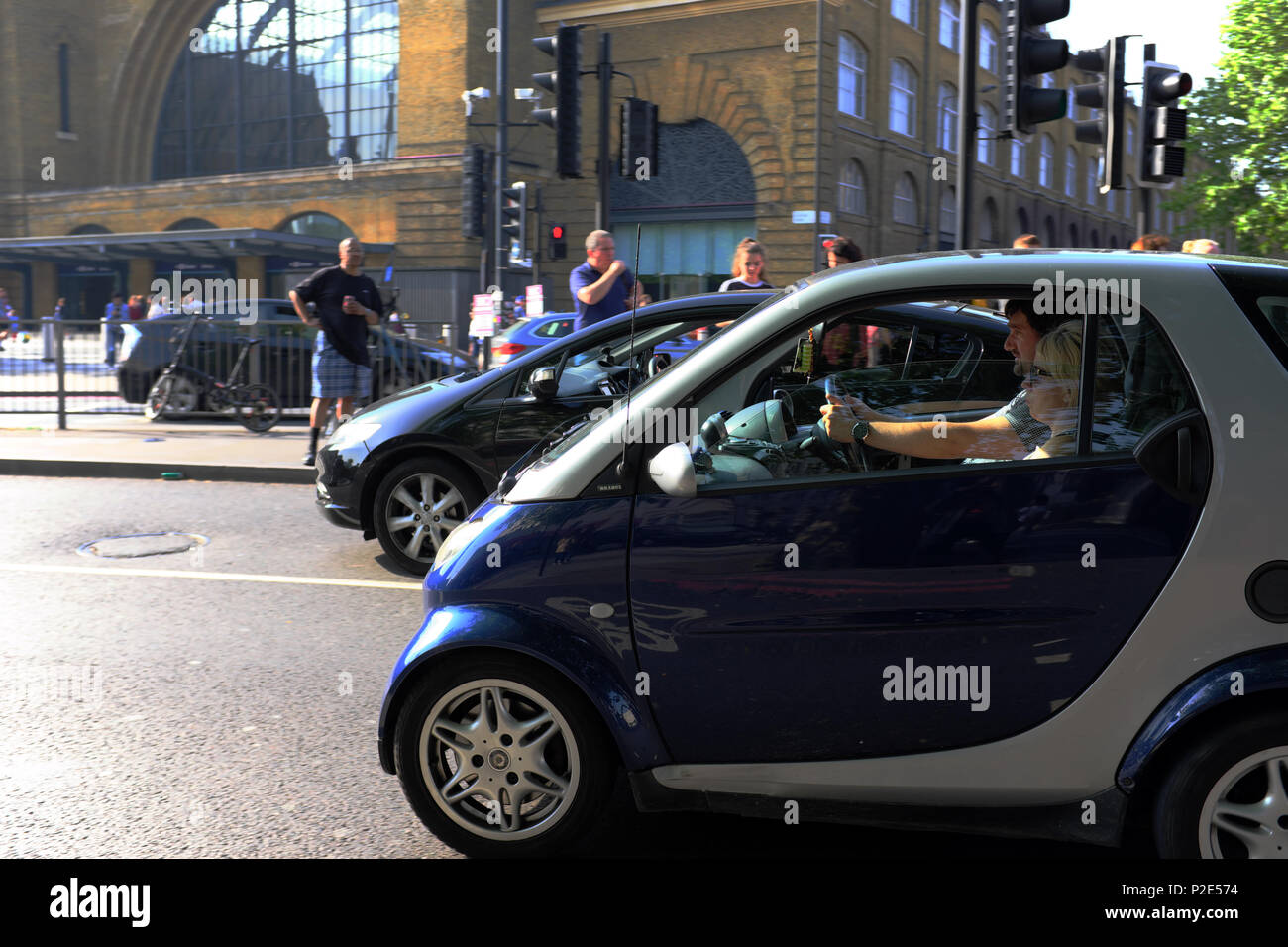 Smart car driven past Kings Cross Station, London, England, UK Stock ...
