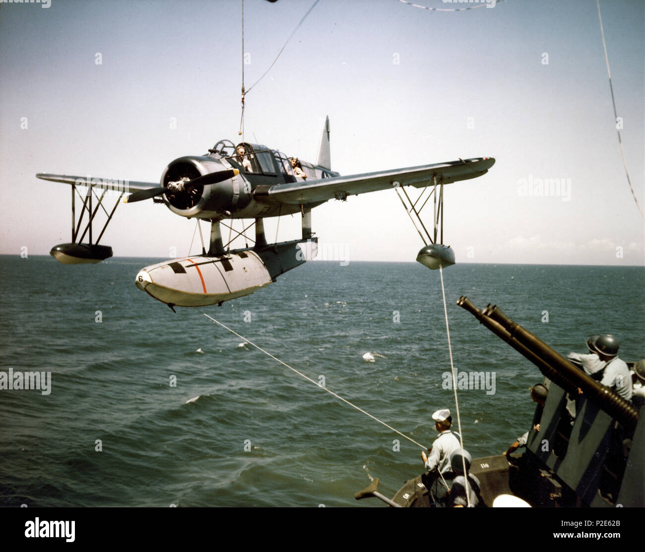 . A Vought OS2U Kingfisher floatplane is hoisted aboard the U.S. Navy ...