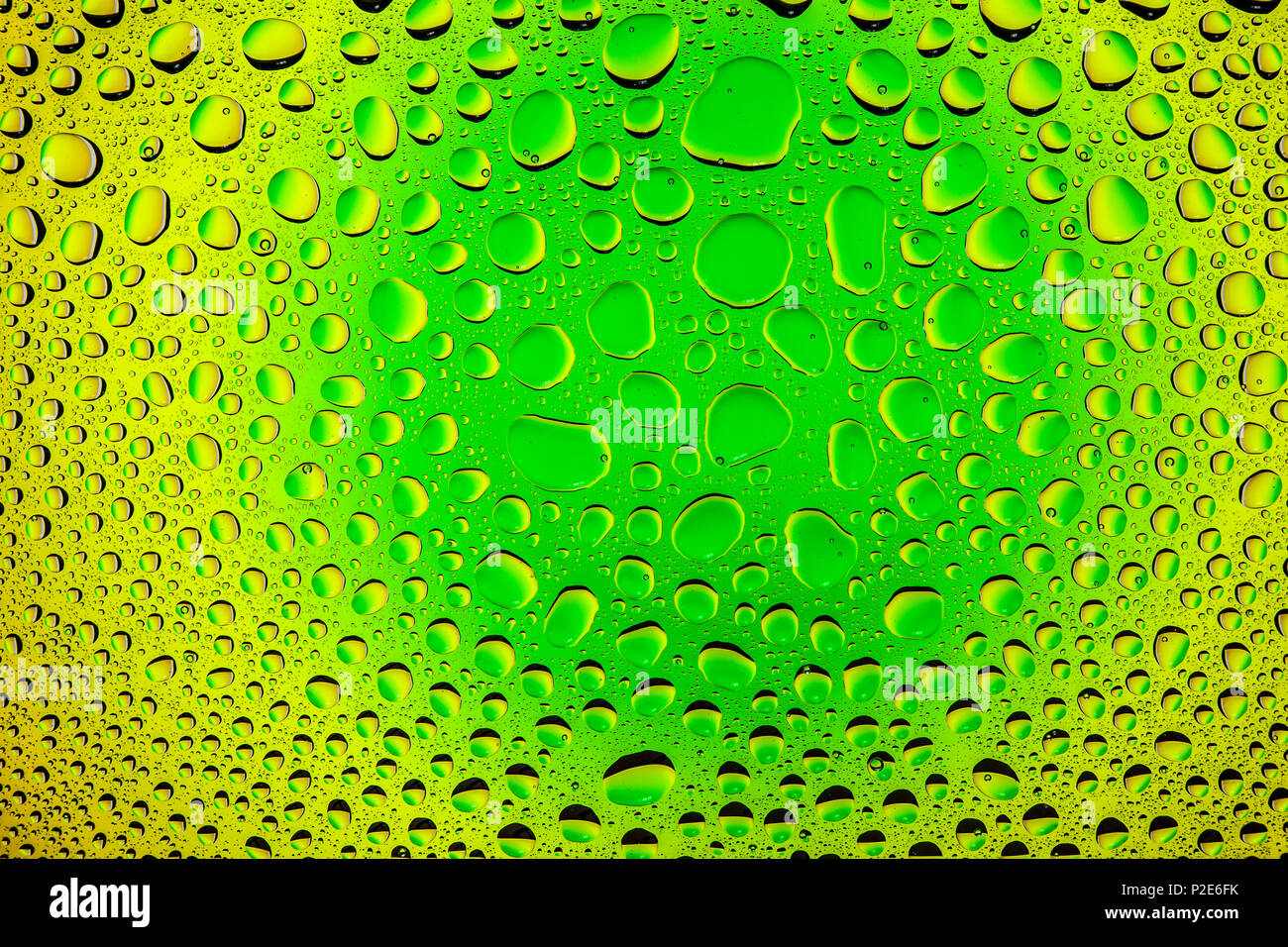 Close up of a water drops on a green and yellow gradient background ...