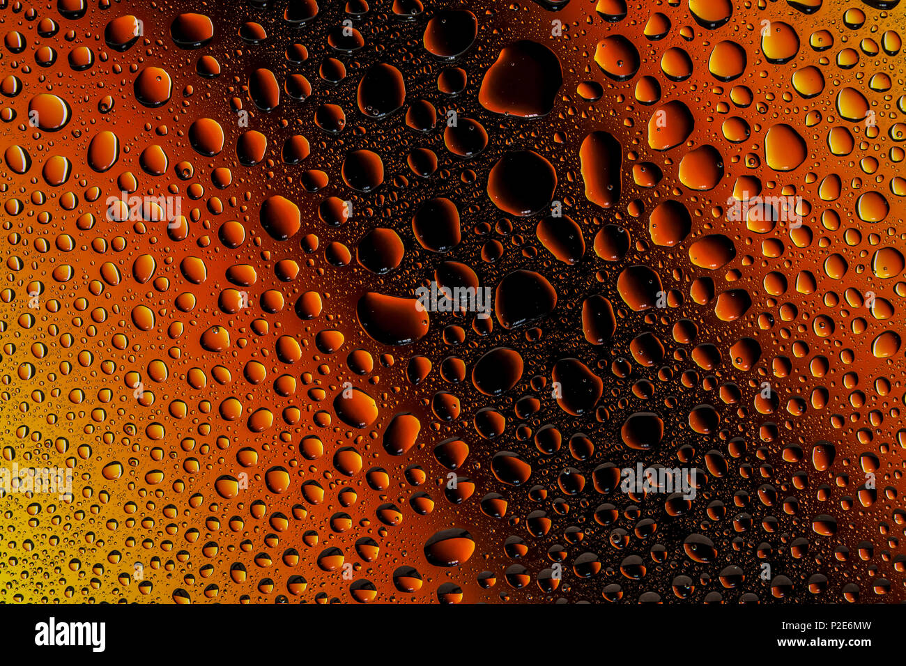 Close up of a water drops on a yellow, orange and brown gradient ...