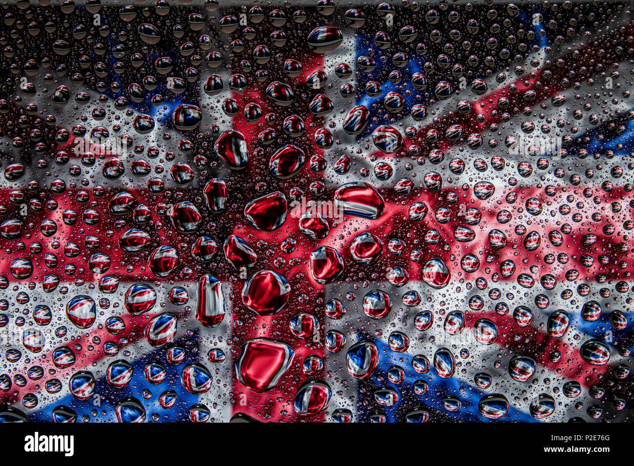 Close-up of a drop of water against a background of the national flag ...