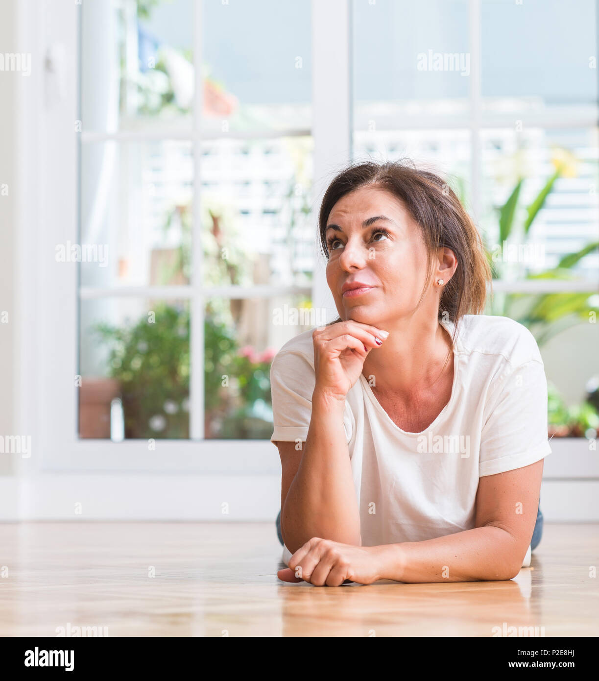 Middle aged woman serious face thinking about question, very confused ...