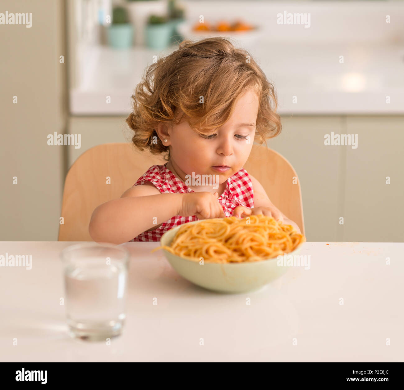 Child eating spaghetti with hands hi-res stock photography and images ...