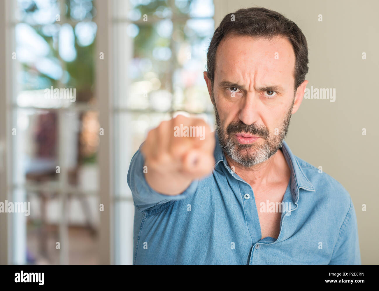 Handsome middle age man pointing with finger to the camera and to you ...