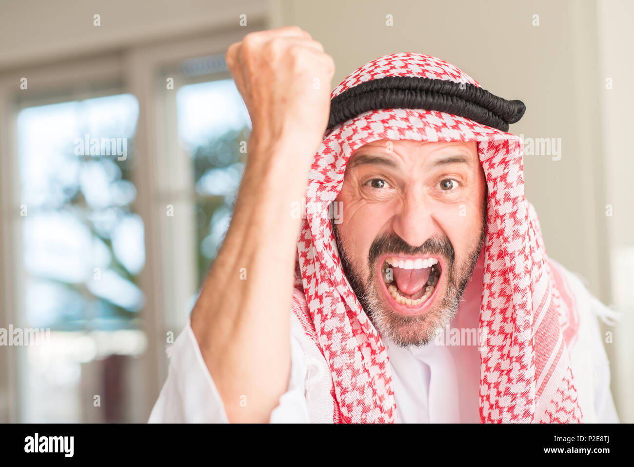 Middle age arabian man at home annoyed and frustrated shouting with ...