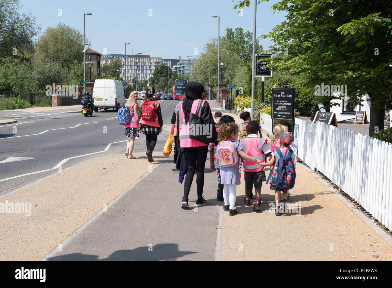 Group of school children wearing pink high visibility vis jackets ...