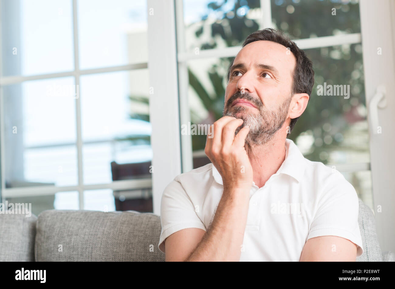 Handsome middle age man serious face thinking about question, very ...