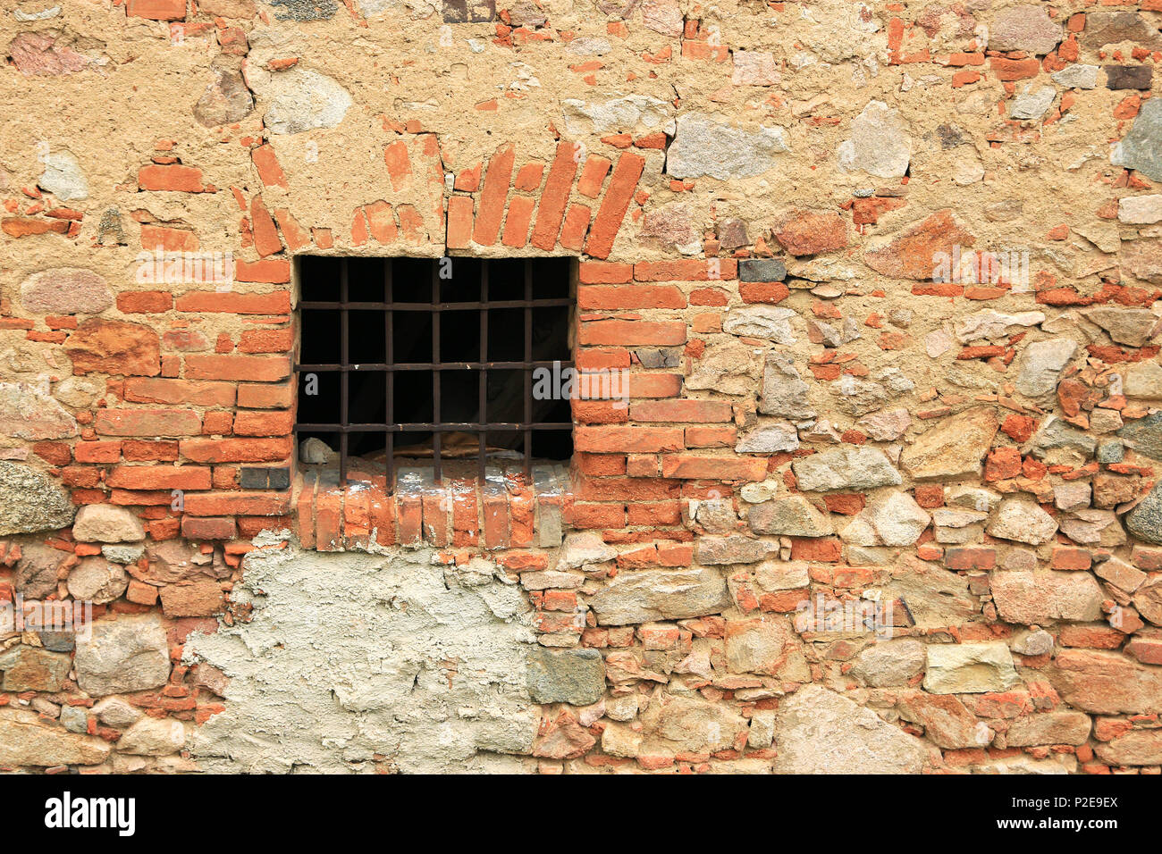 Rusty window grille and old block brick wall Stock Photo - Alamy