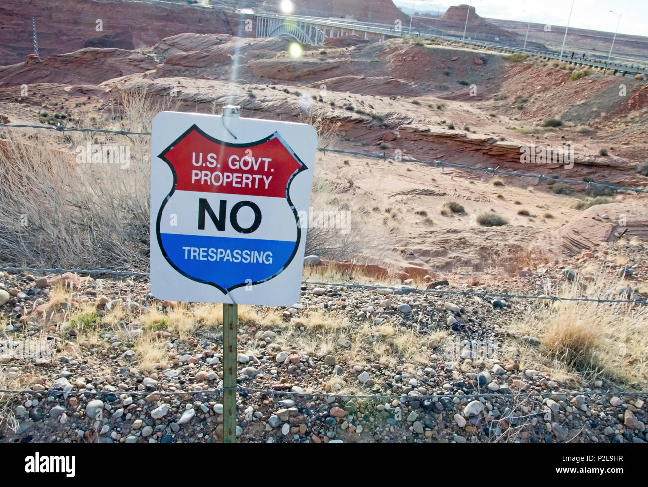 A U.S. Goverment Property Sign in the desert with flare from the sunset ...