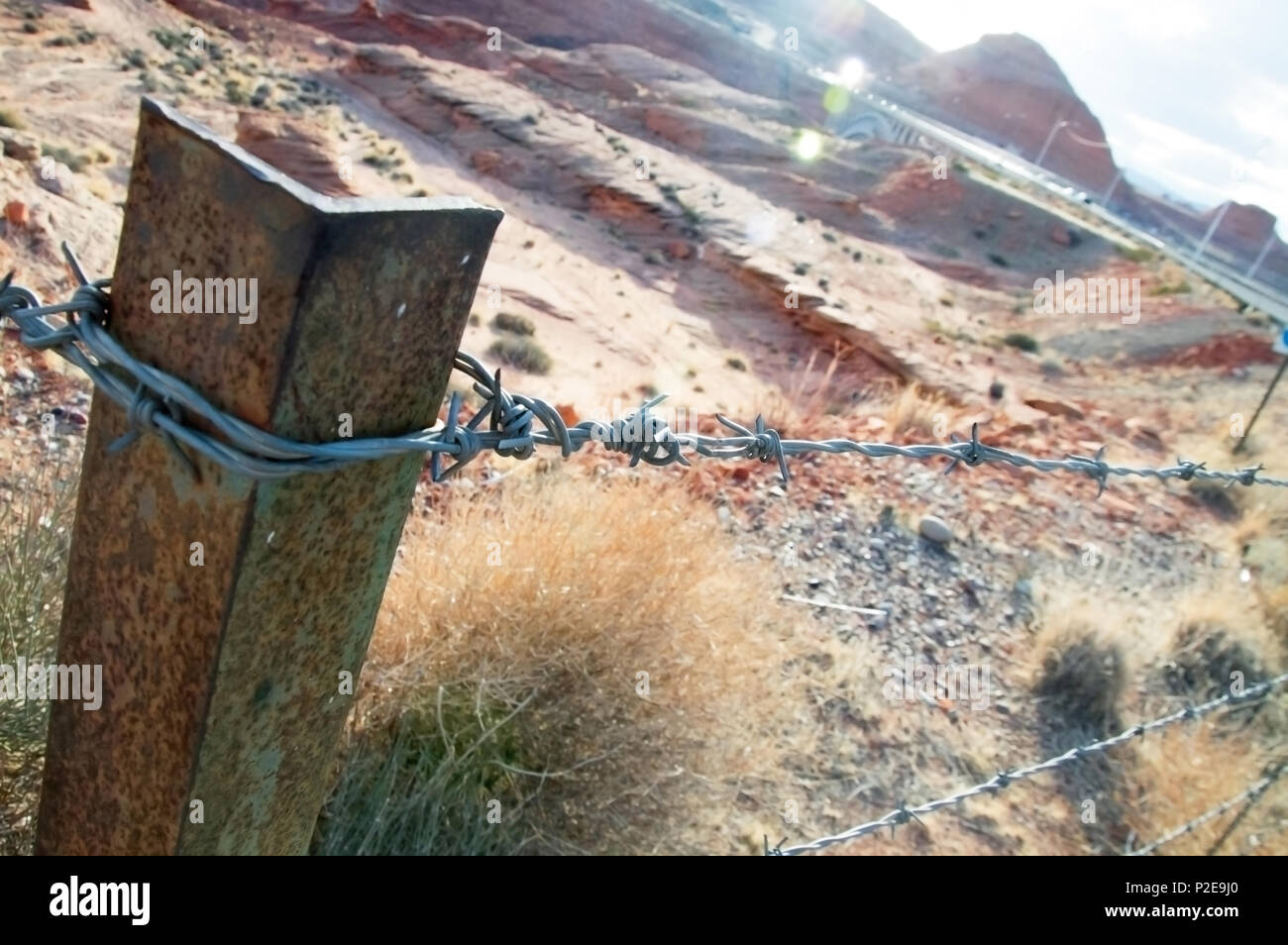 A barbed wire fence in the desert at sunset Stock Photo - Alamy