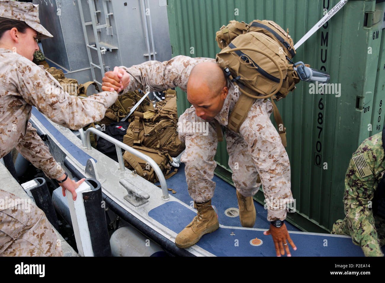 U.S. Marine Maj. David Rainey,with Task Force Koa Moana, steps off of a ...
