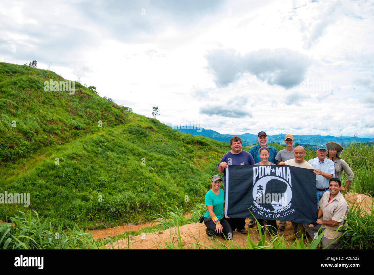 Members of the Defense POW/MIA Accounting Agency (DPAA) pose for a ...