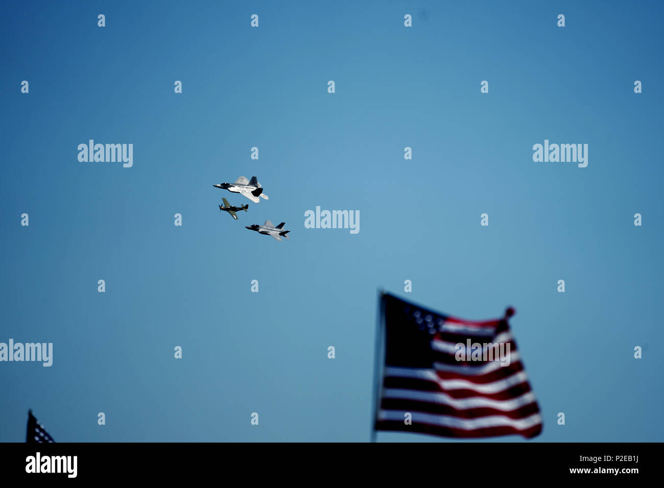 An F-22 Raptor, P-51 Mustang and F-35 Lightning fly in unison during a ...