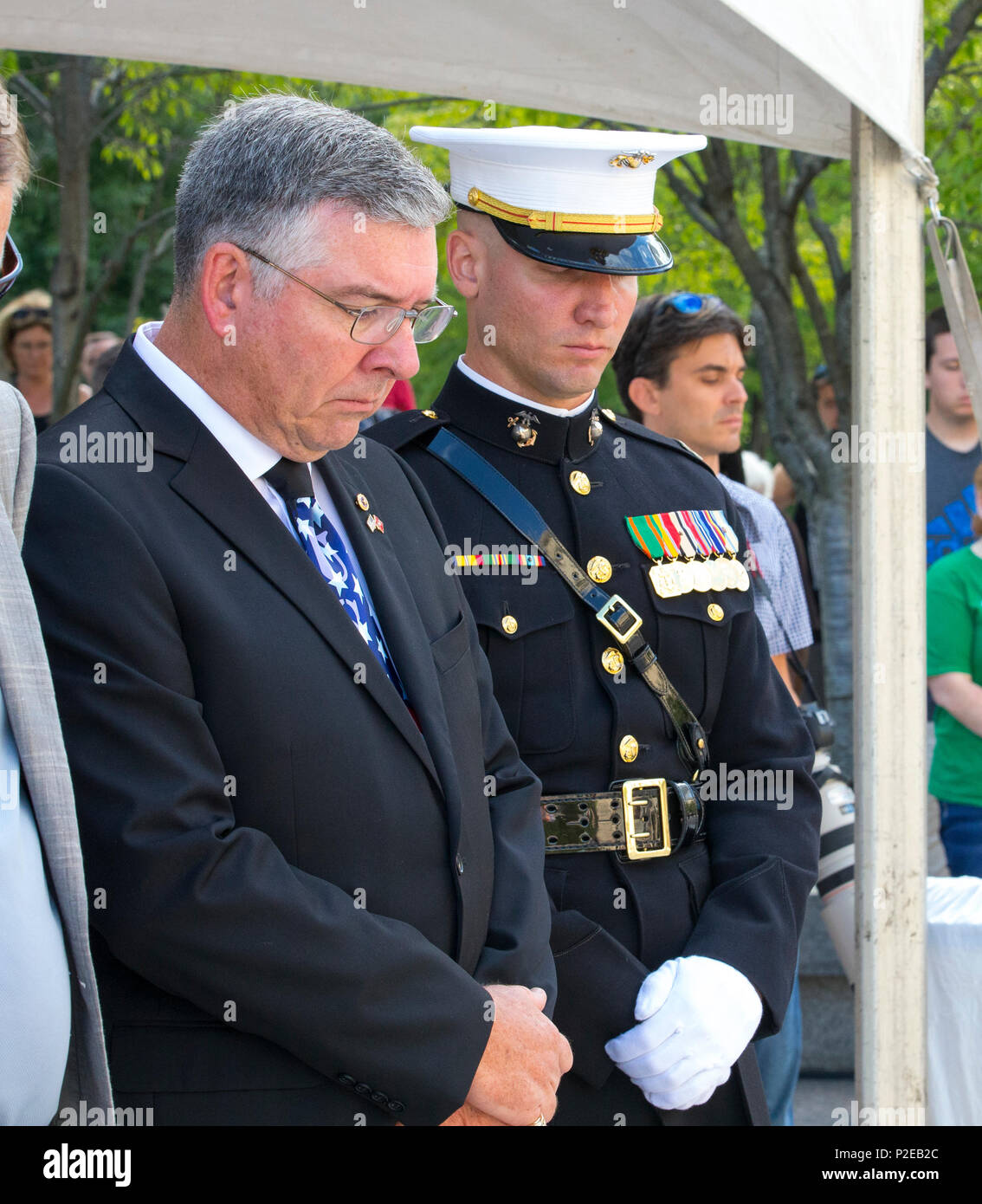 Capt. Eric M. Montgomery, right, and his father, left, bow their heads ...