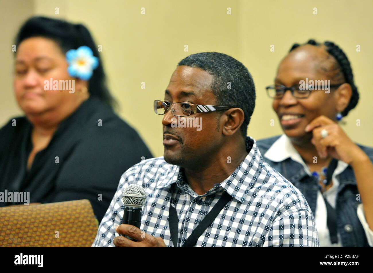 Reginald Howell (center) elicits laughter from his wife Sgt. 1st Class ...