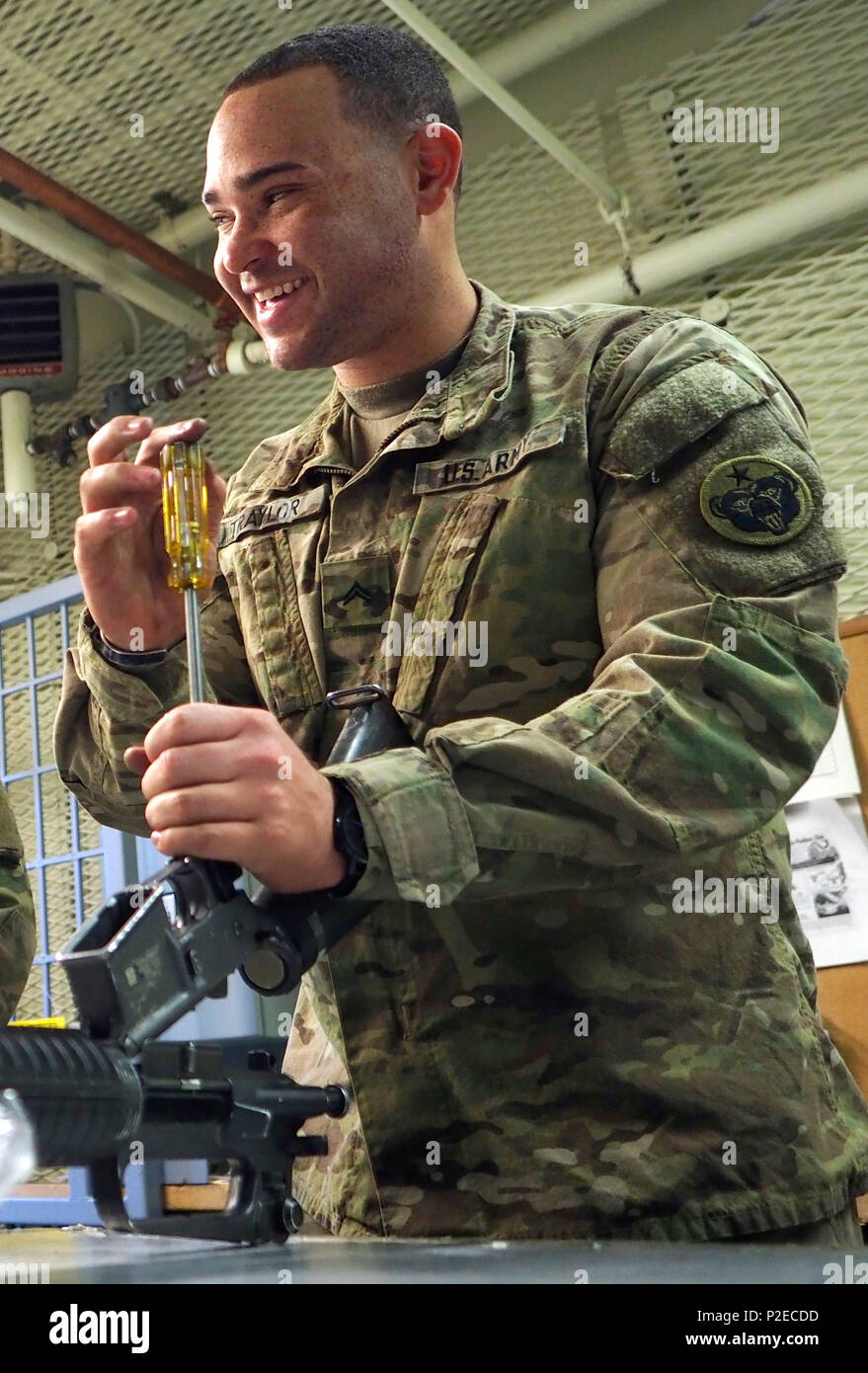 Army Cpl. Gregg Traylor, a native of St. Paul, Minn., smiles as he and ...