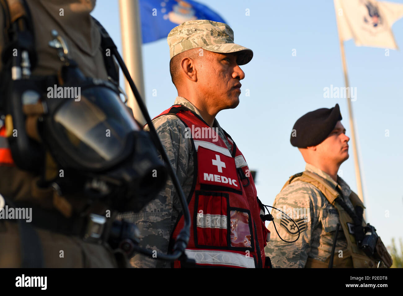 A U.S. Air Force firefighter, medic, and police officer stand at ...