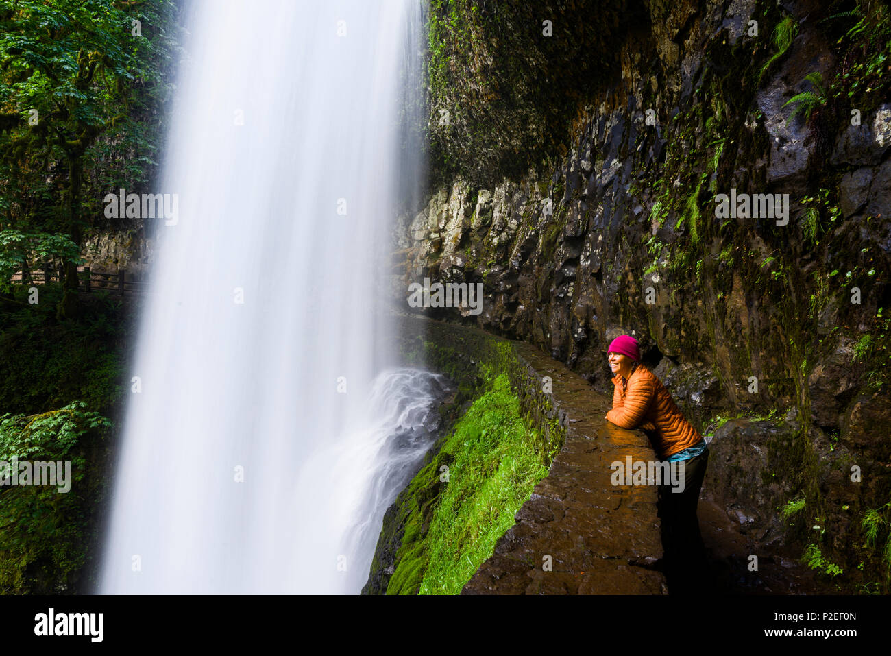 A woman wateches from the trail behind Lower North Falls at the Silver ...