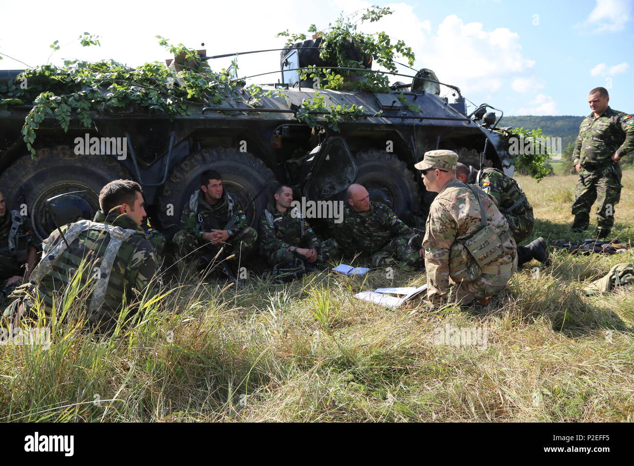 U.S. Army Capt. Marcus Smith, center right, of Warhog Observer Coach ...
