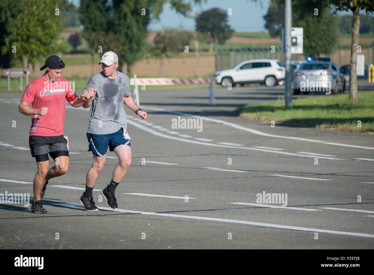 Two runners bump their fists as they participate in the Patriot Run, a ...