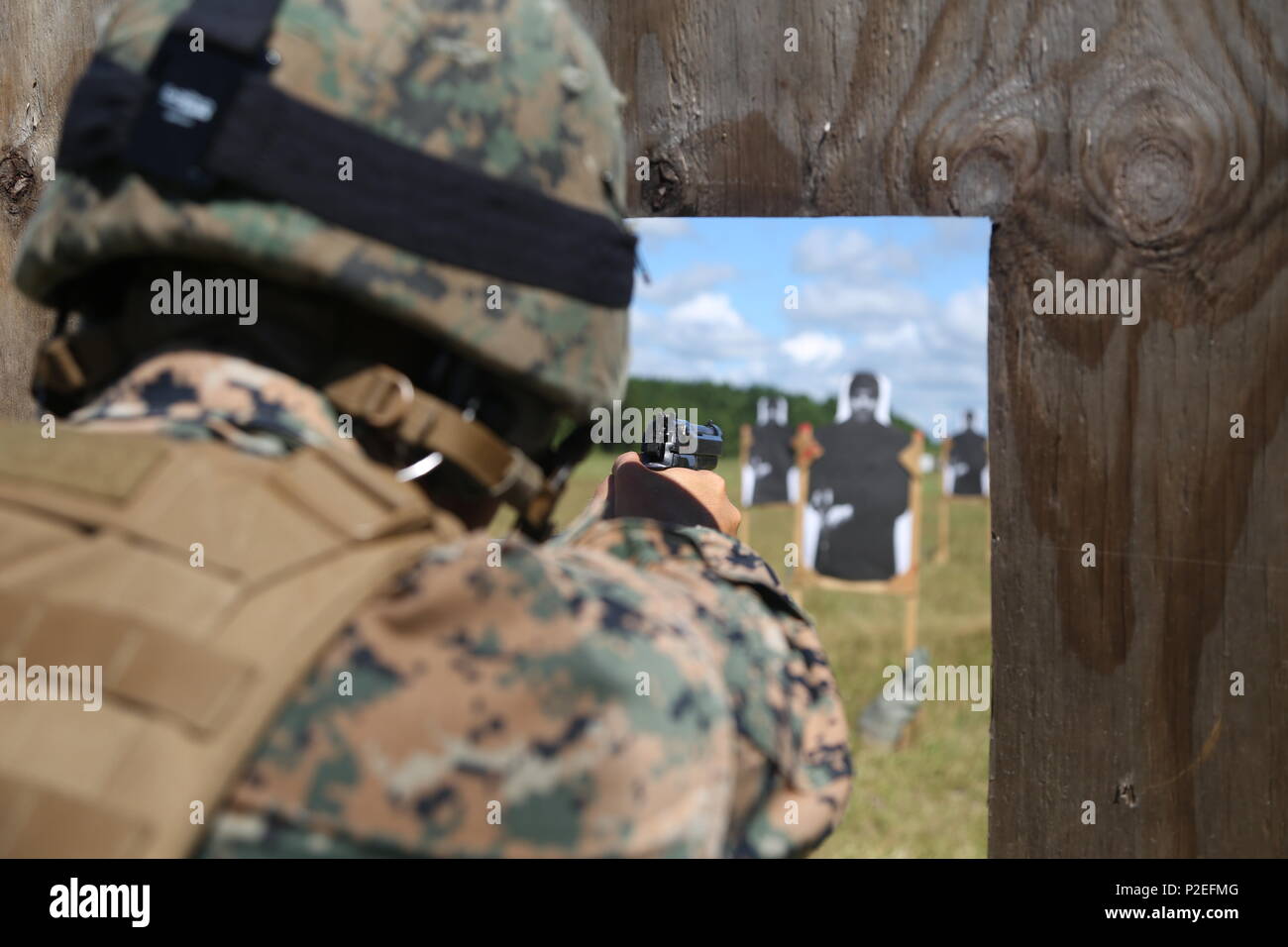 Sgt. James Jackson, Stone Bay alpha range line staff, fires an M9 ...