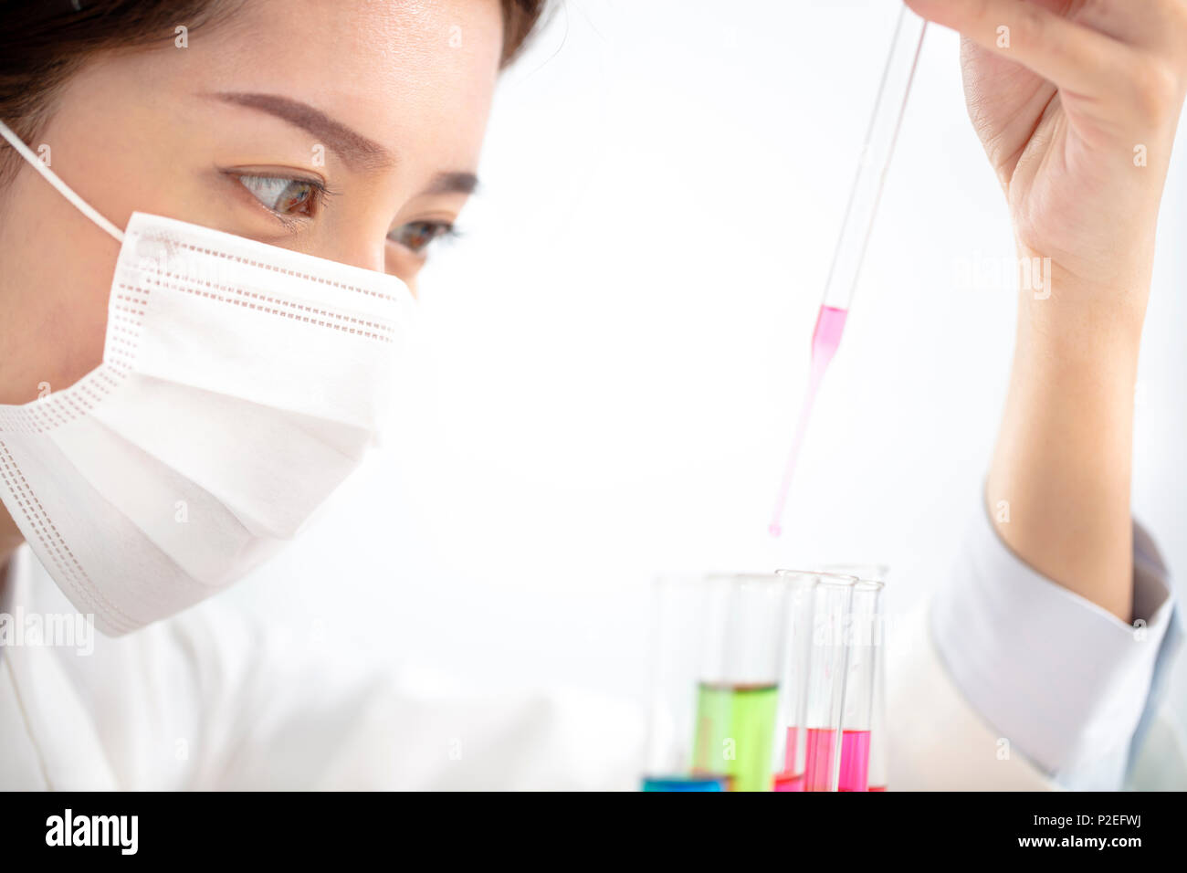 asian female scientist looking at test tube Stock Photo - Alamy