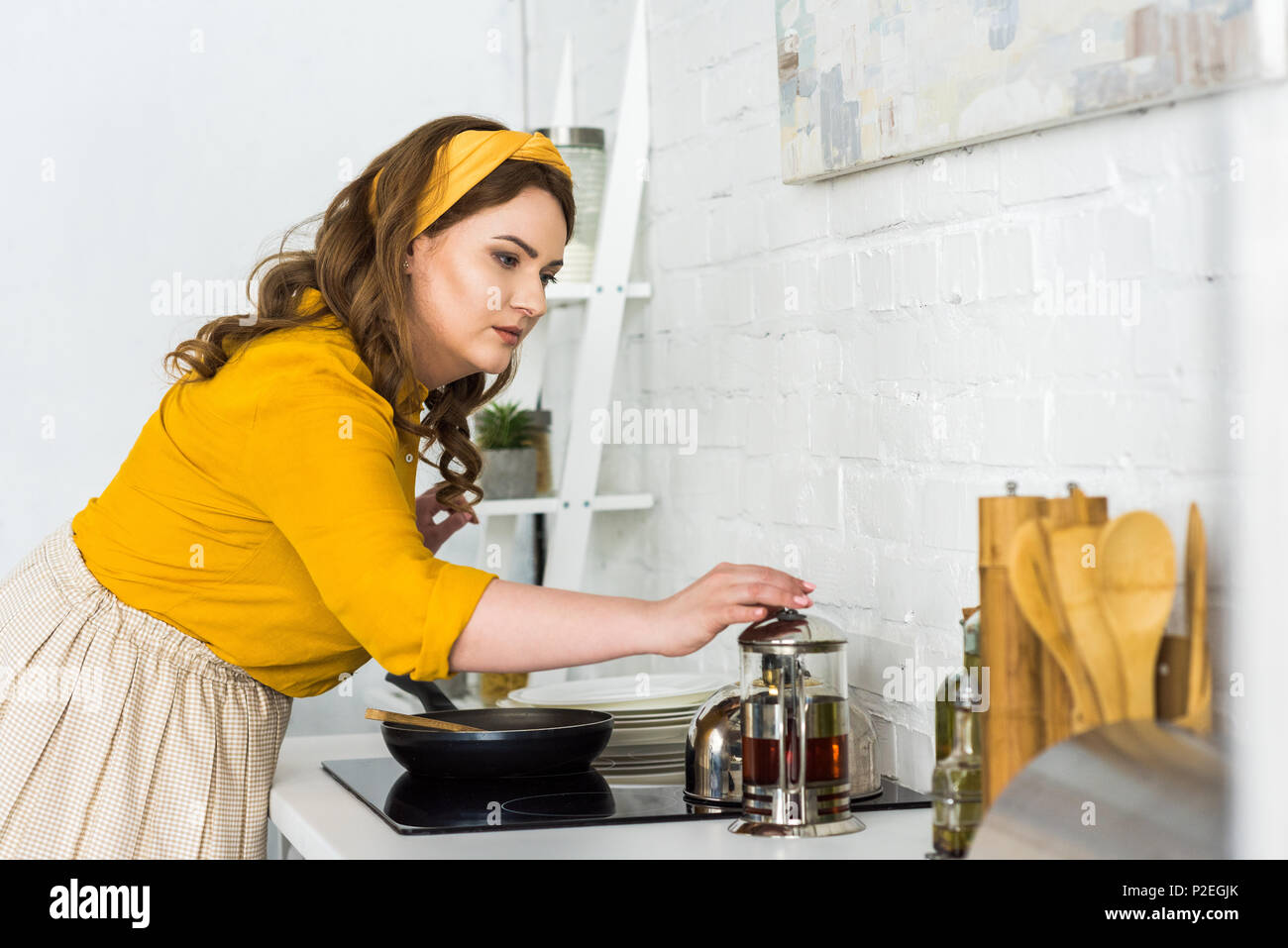 side view of beautiful woman cooking in kitchen Stock Photo - Alamy