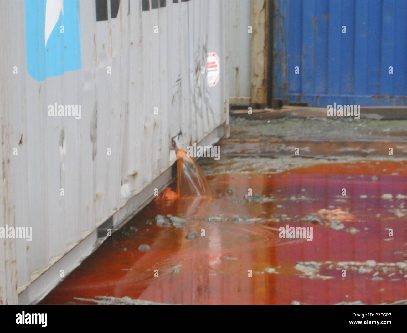 An unknown amount of spilled fish oil pools on the ground near a ...