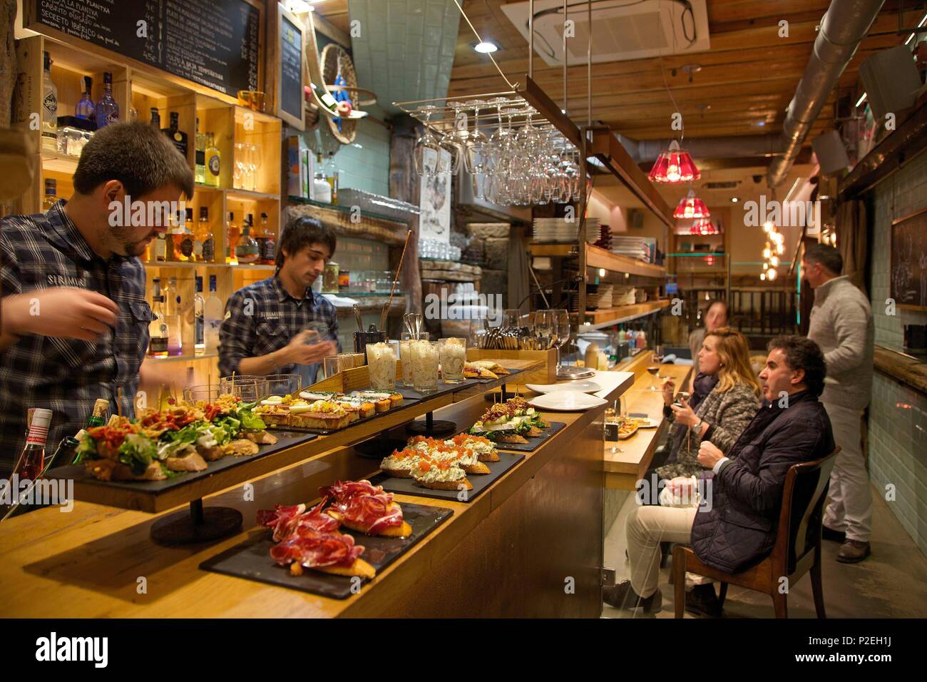 Spain, Basque country, San Sebastian, Sirimiri bar servers in front of ...