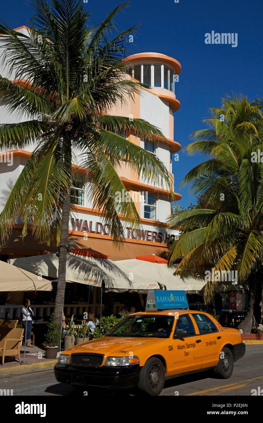 United States, Florida, Miami, Yellow cab passing in front of the ...