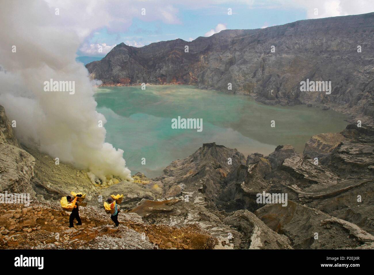 Indonesia, Java, Ijen, Sulfur carriers from the crater smoking ...