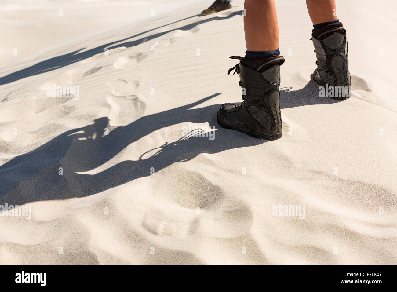 Person standing in sand on a sunny day Stock Photo - Alamy
