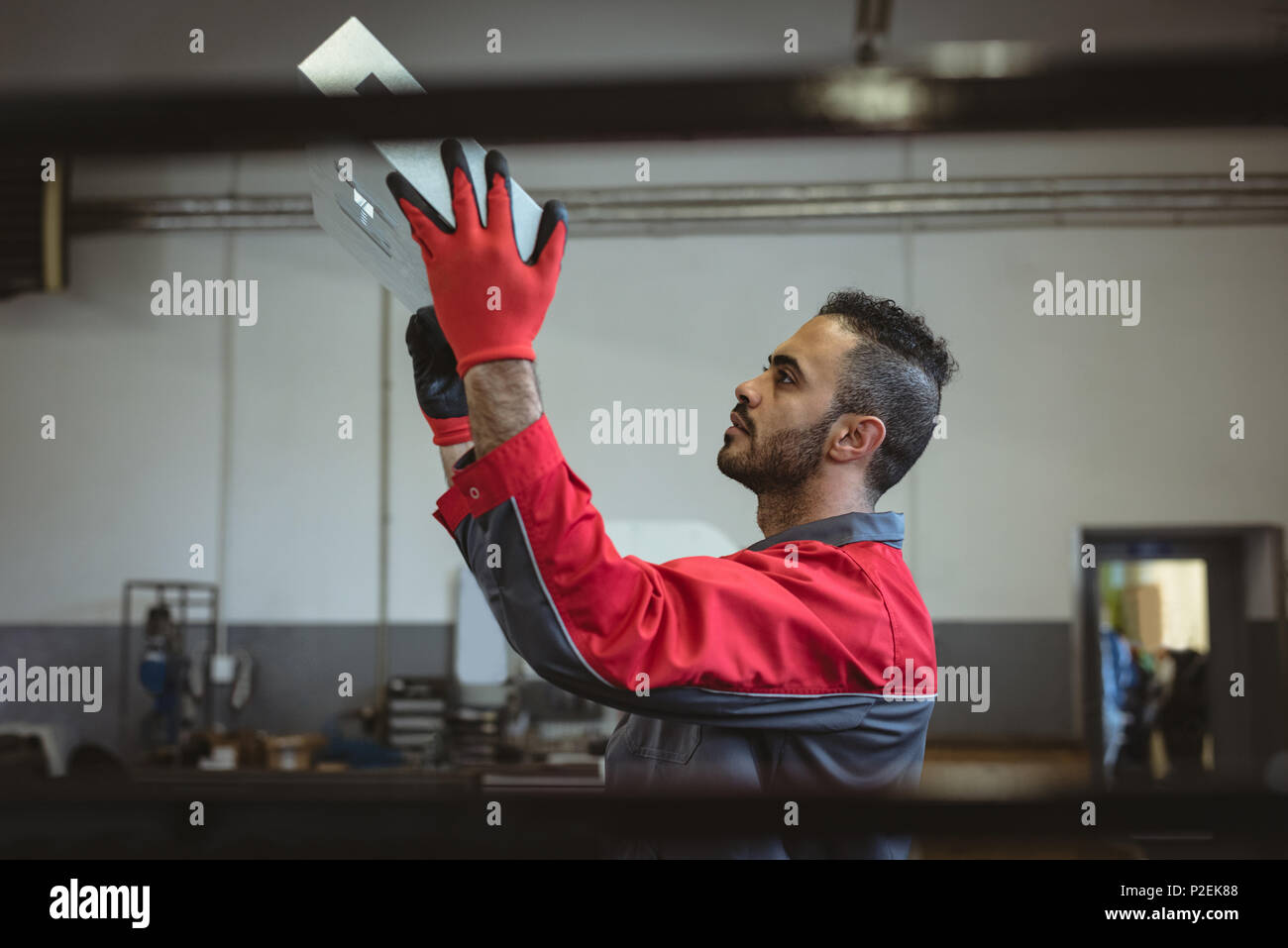 Male worker checking a machine board Stock Photo - Alamy