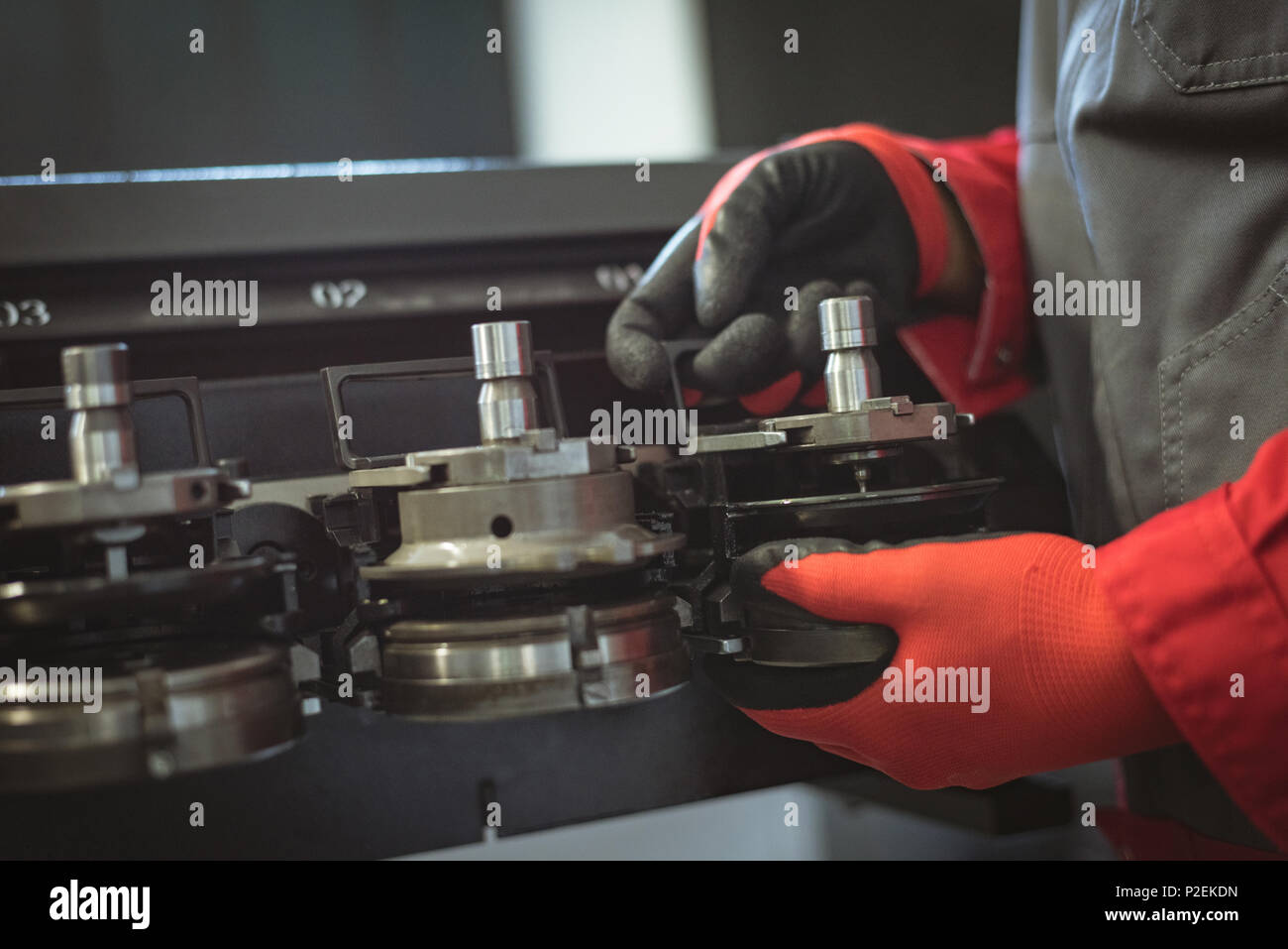 Male worker checking a machine part Stock Photo - Alamy