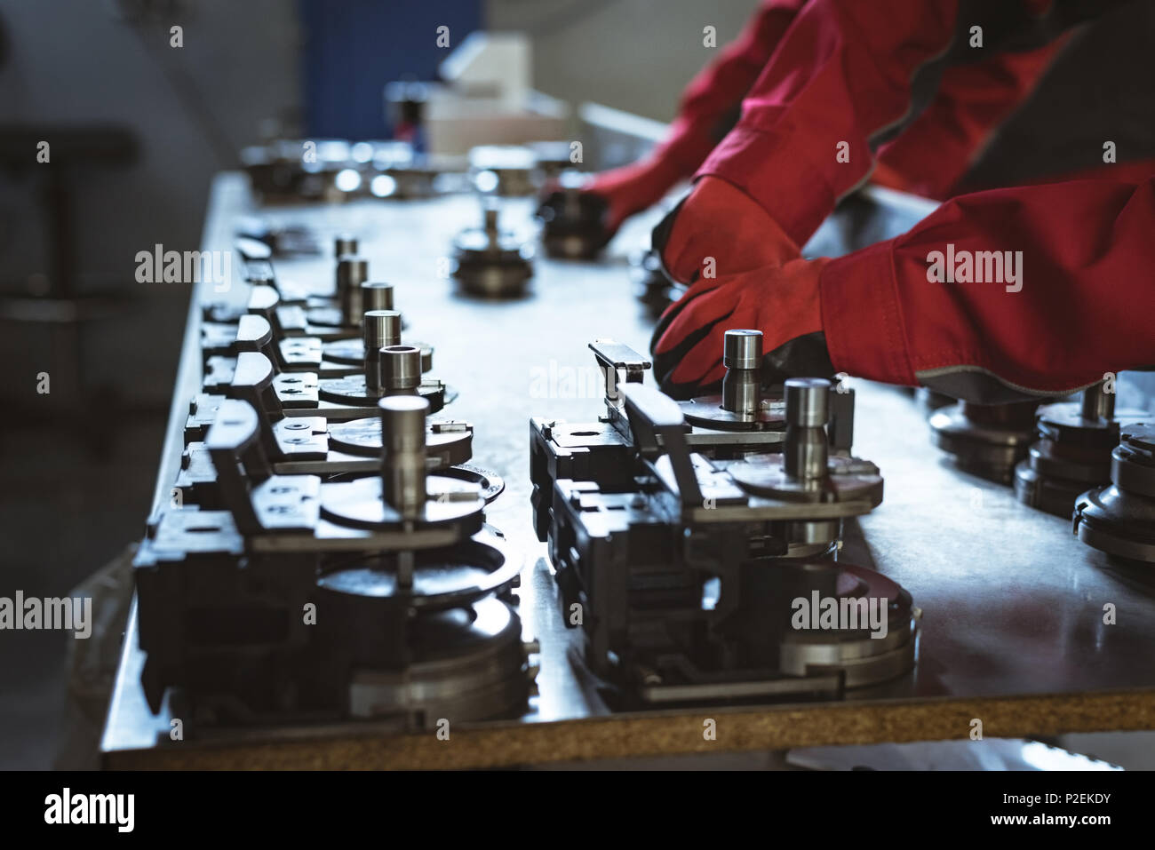 Two workers checking machine parts Stock Photo - Alamy