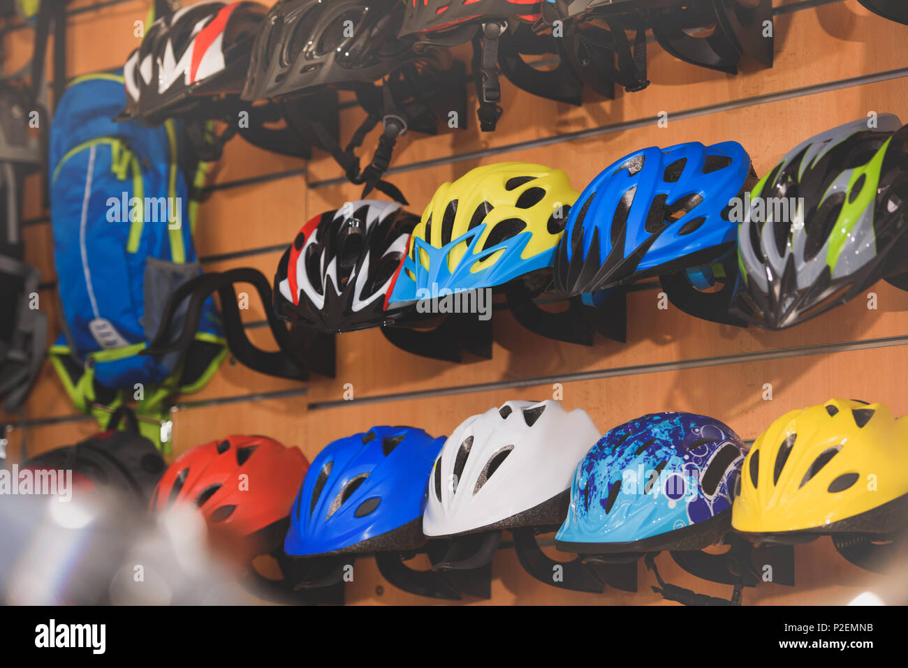 various colorful helmets displayed in bicycle shop Stock Photo - Alamy