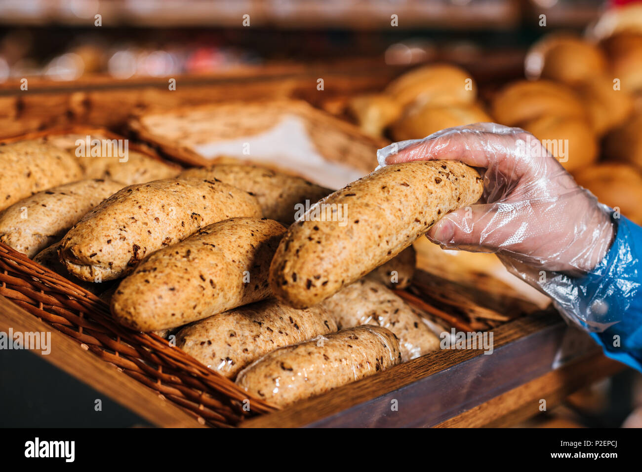 partial view of shopper taking loaf of bread in grocery shop Stock ...