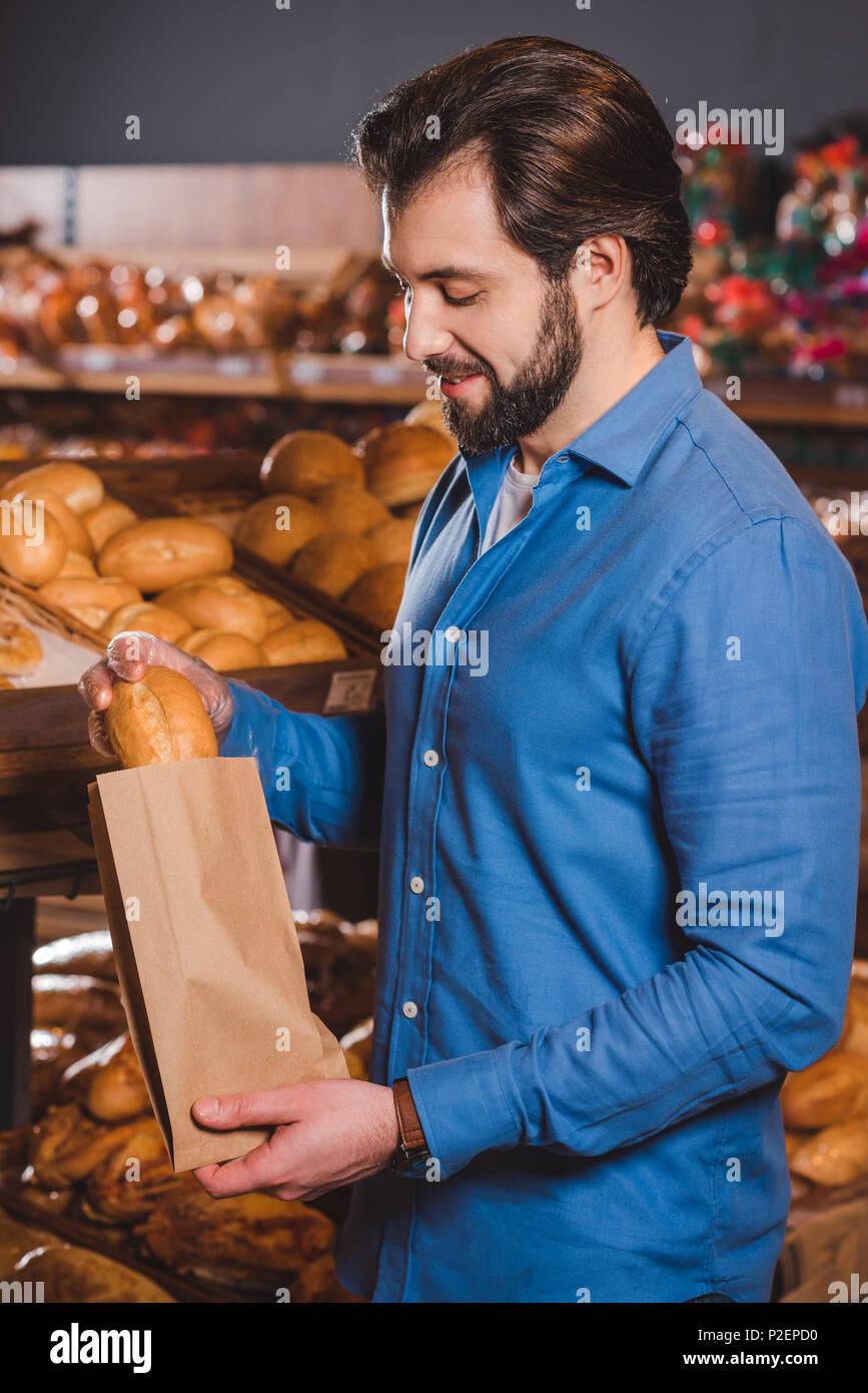 side view of smiling man choosing bread in hypermarket Stock Photo - Alamy
