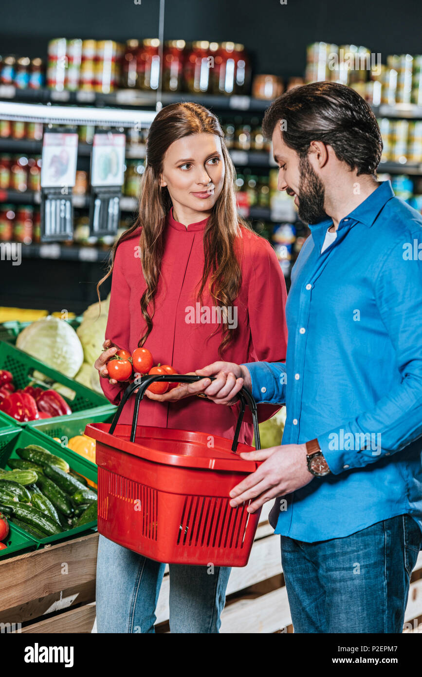 couple with shopping basket shopping together in supermarket Stock ...