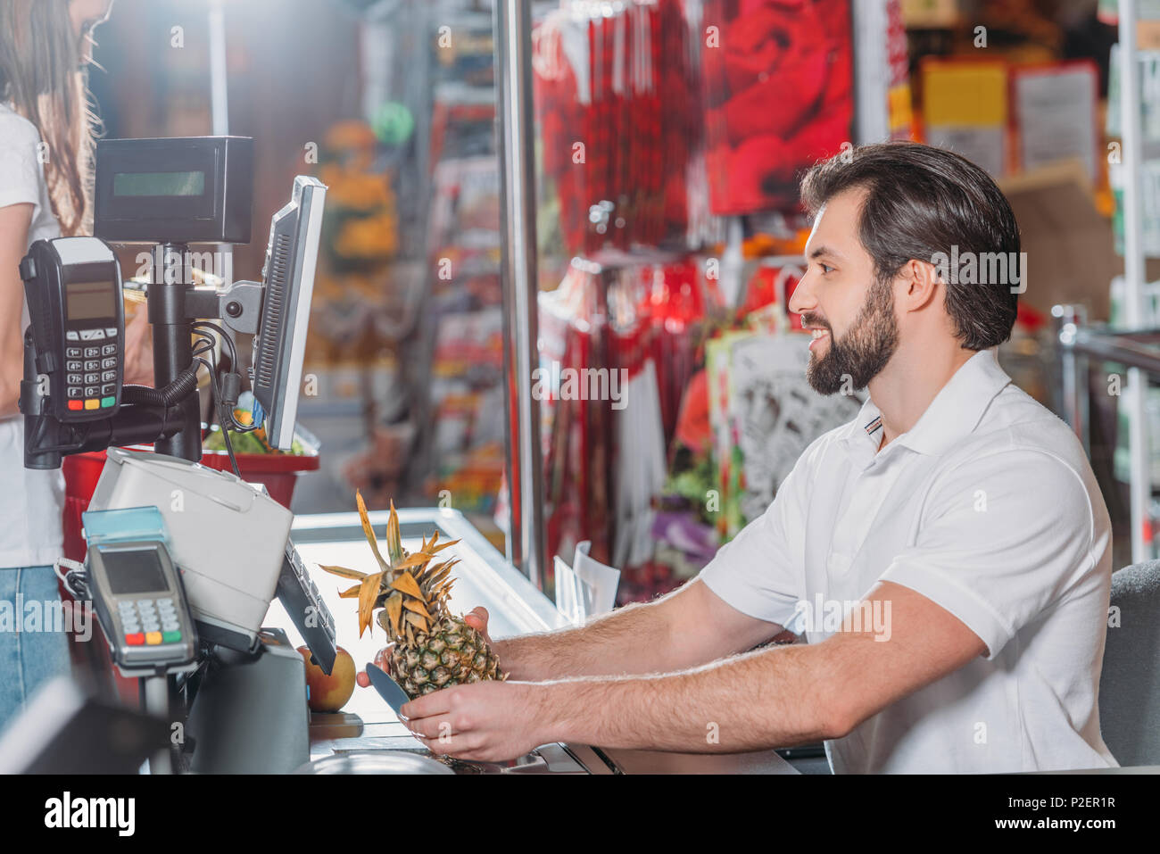 side view of shop assistant at cash point in supermarket Stock Photo ...