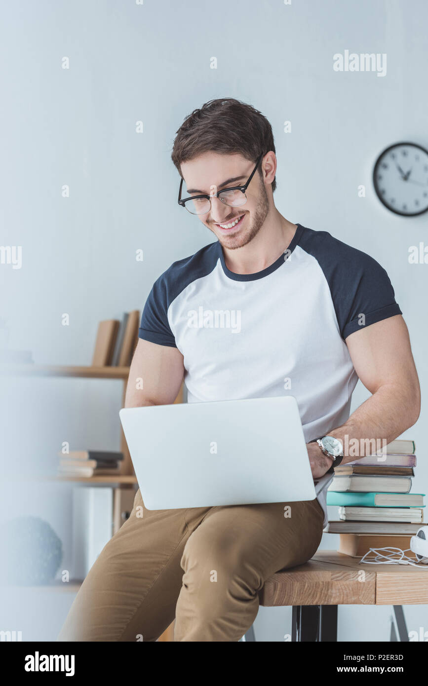 smiling student learning and using laptop Stock Photo - Alamy
