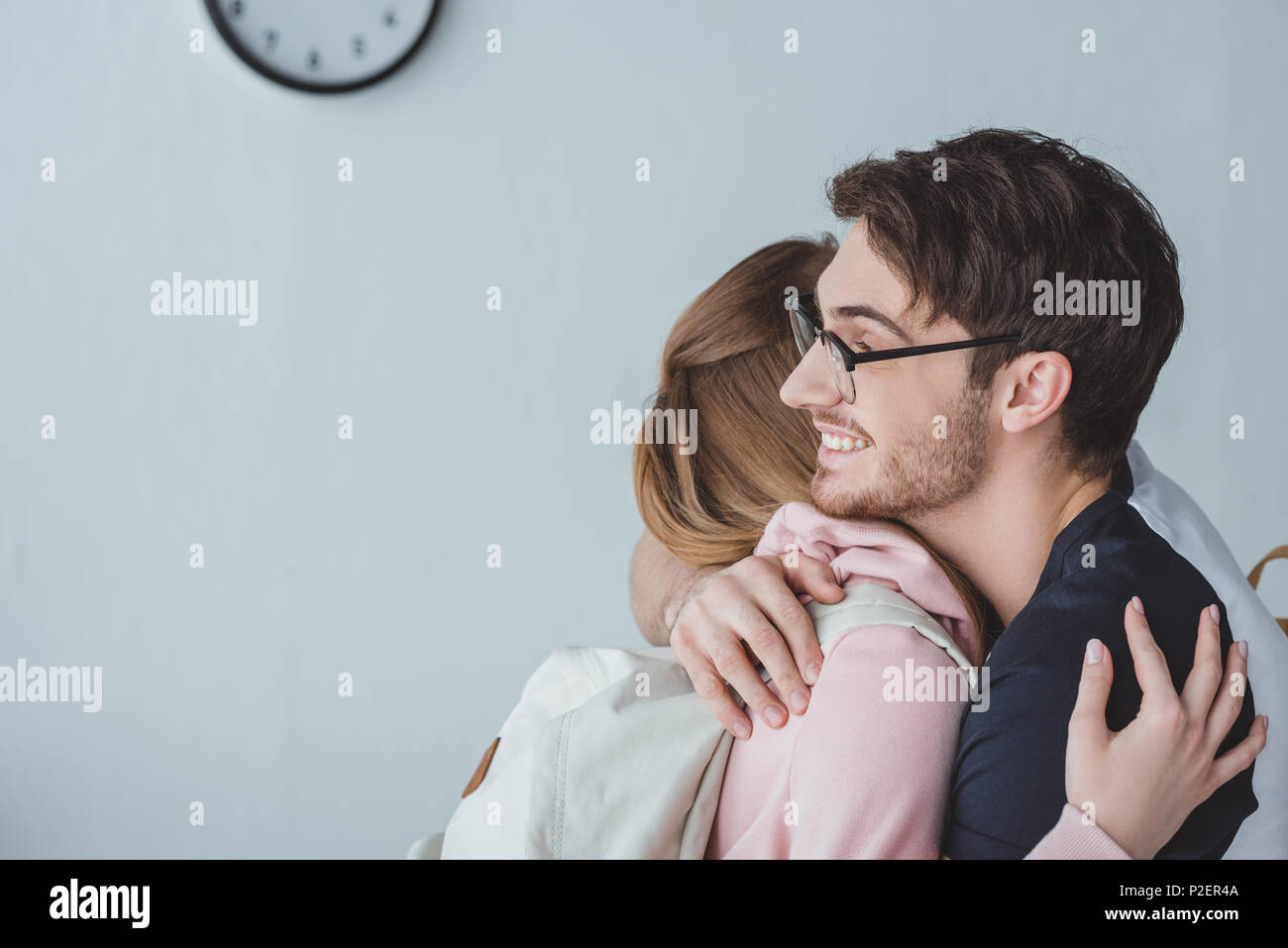 happy man hugging girl with backpack Stock Photo - Alamy